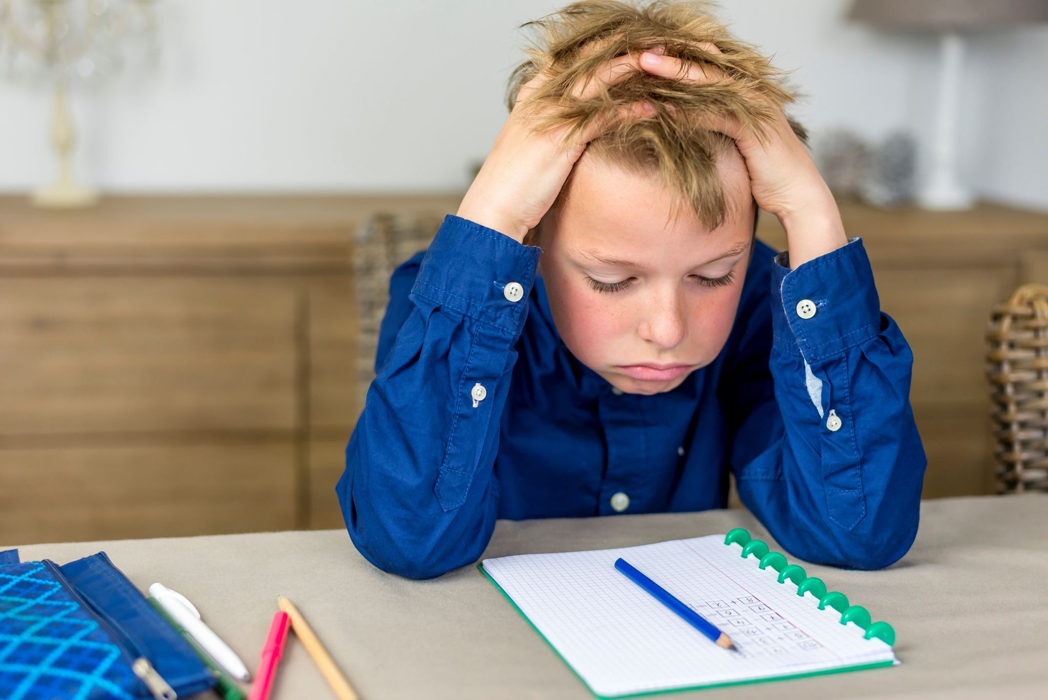 Young boy struggling with his homework | Studer Education